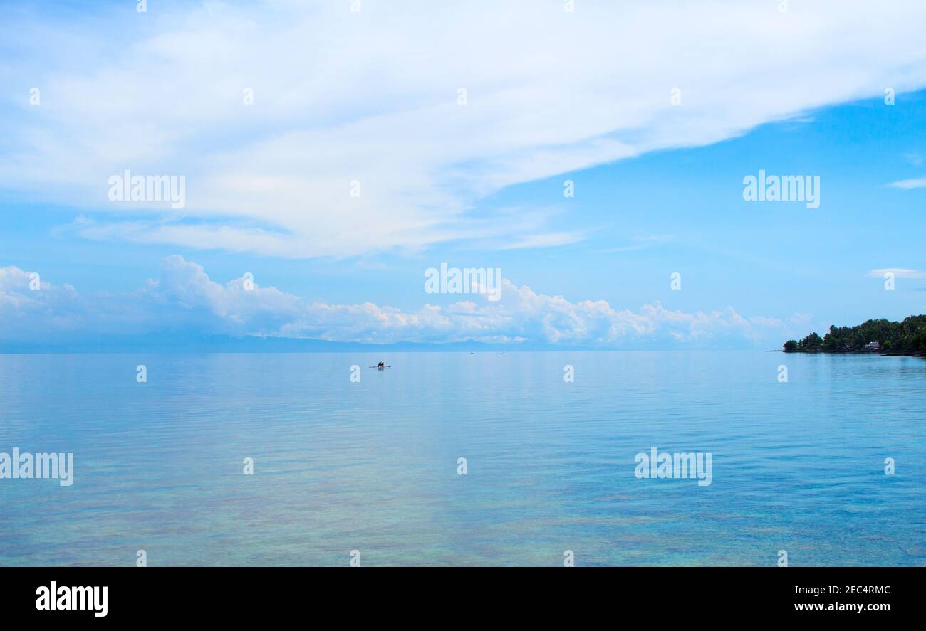Blue seascape with fishing boat and blue sky. Relaxing sea view with ...