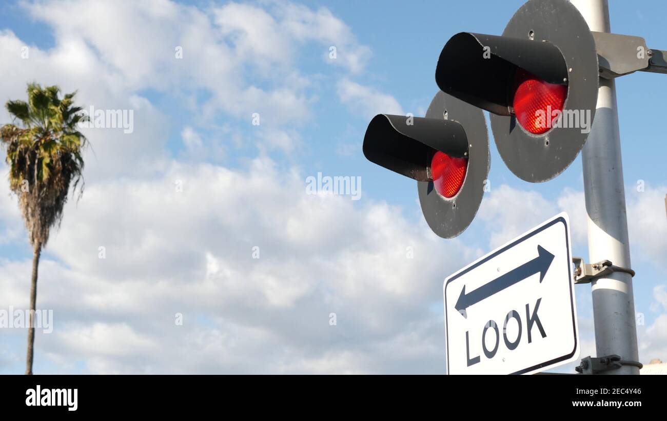 Level crossing warning signal in USA. Crossbuck notice and red traffic ...