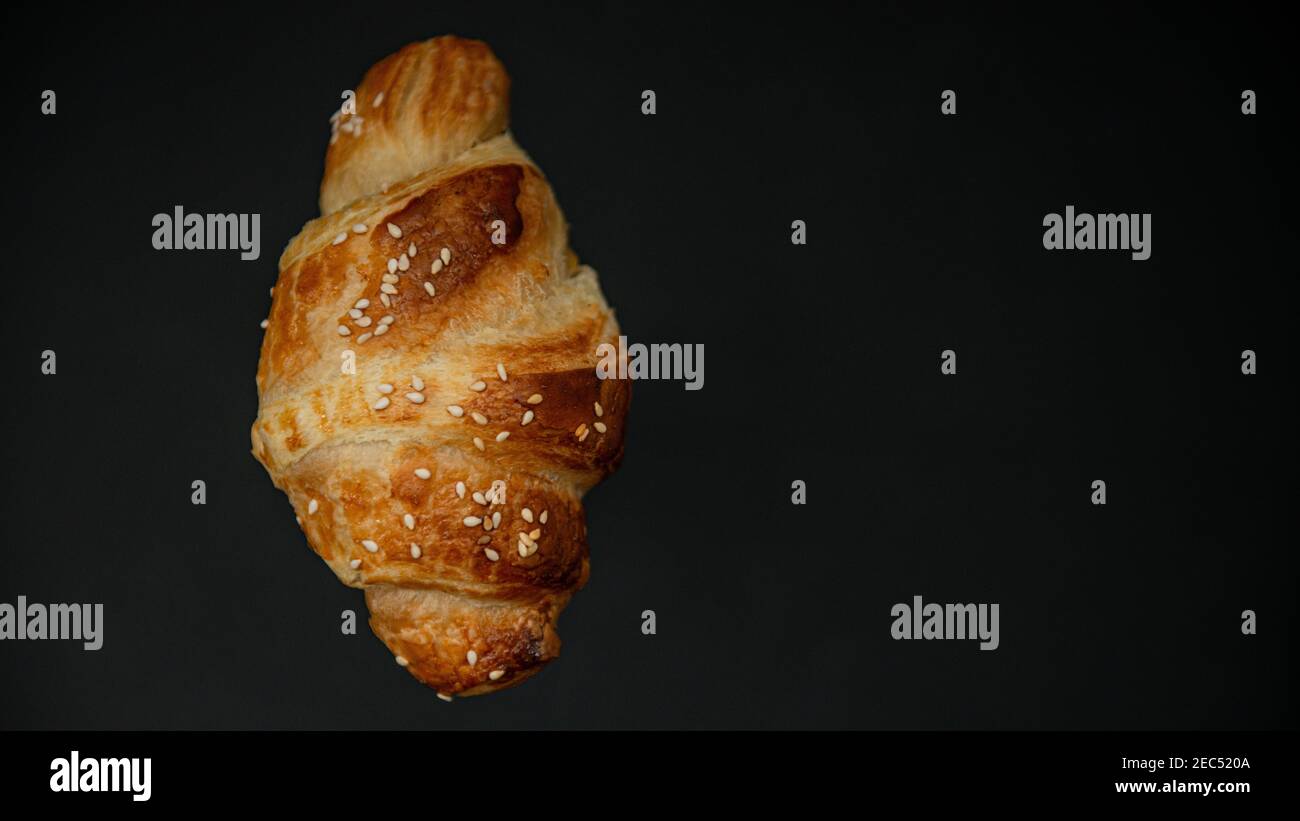 French croissant on a black background Stock Photo - Alamy