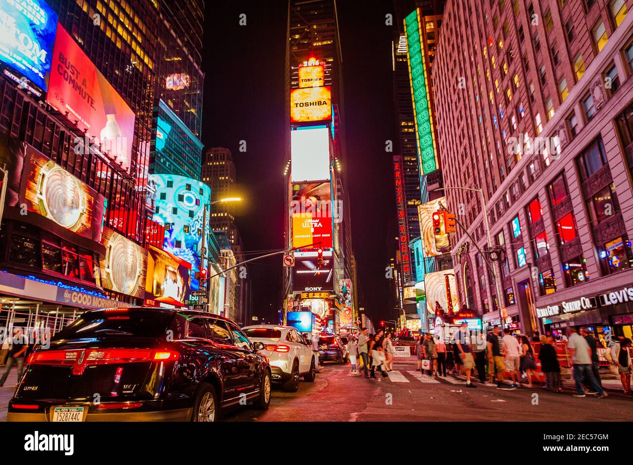 Blurred cars and people walking at Times Square at night Stock Photo ...