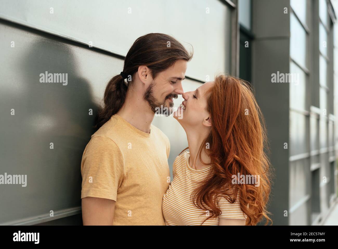 Loving Couple Touching The Tips Of Their Noses In A Gesture Of