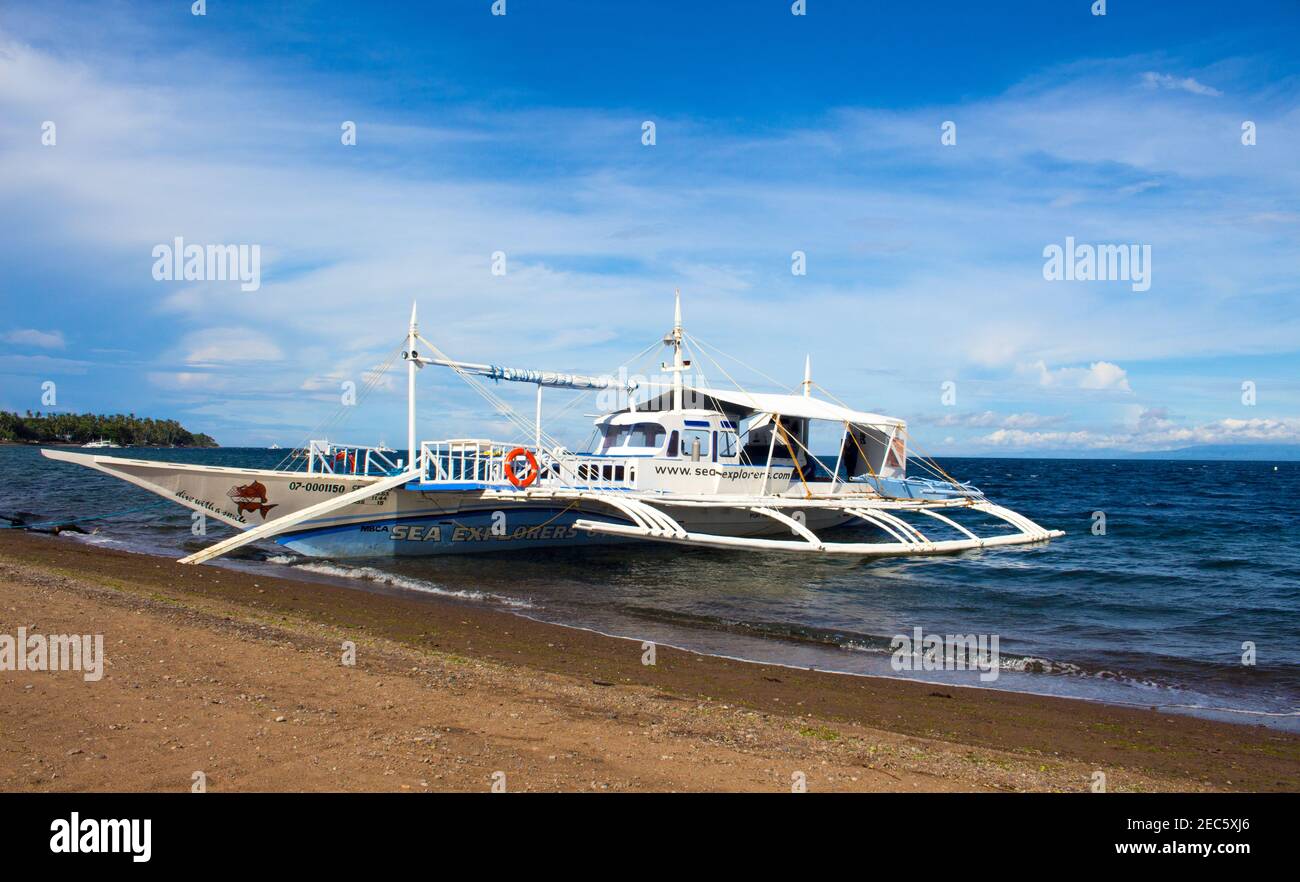 Dauin, Philippines - 1 March, 2017: Boat near the beach. White wooden ...