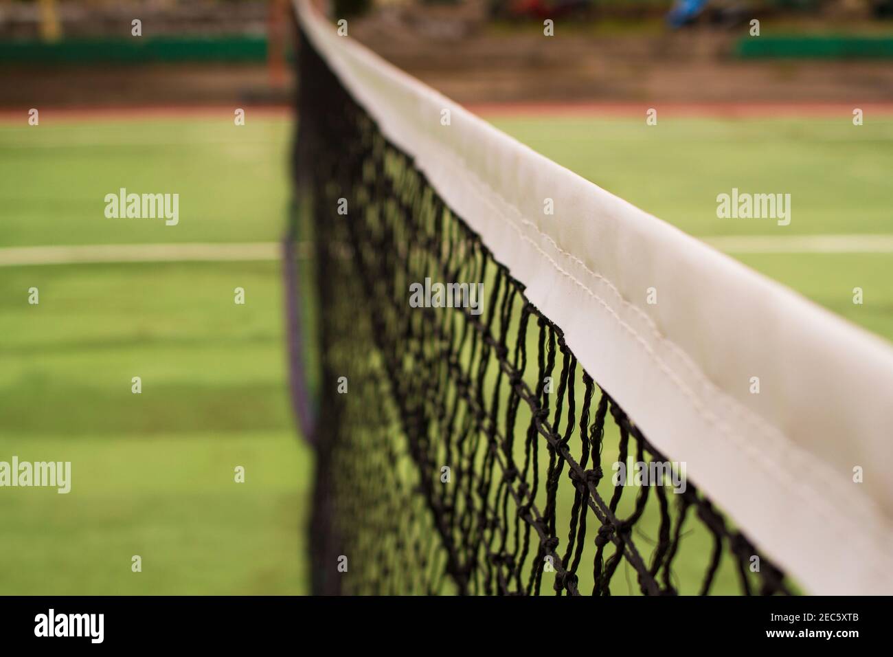 Tennis court net in warm sunlight. Tennis court divider. Opposite sites ...