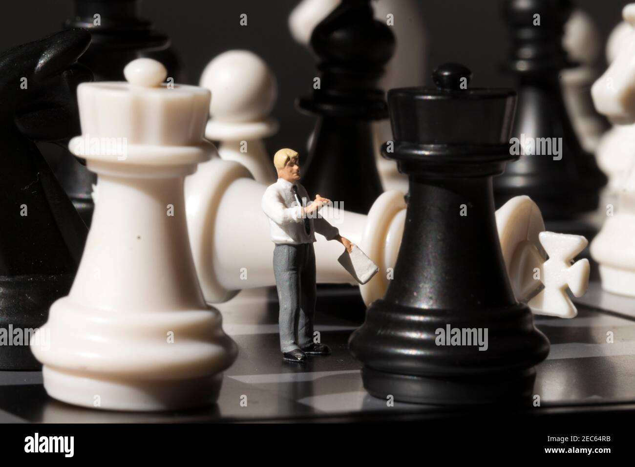 Chessman and chess king fall on game board. Playing chess with ...