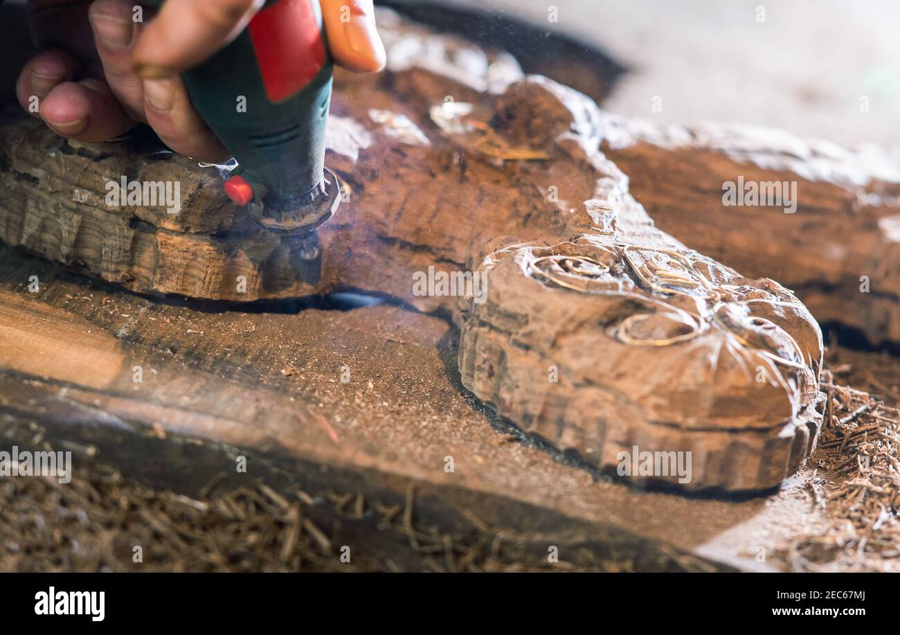 wood carving with electric tools closeup Stock Photo - Alamy