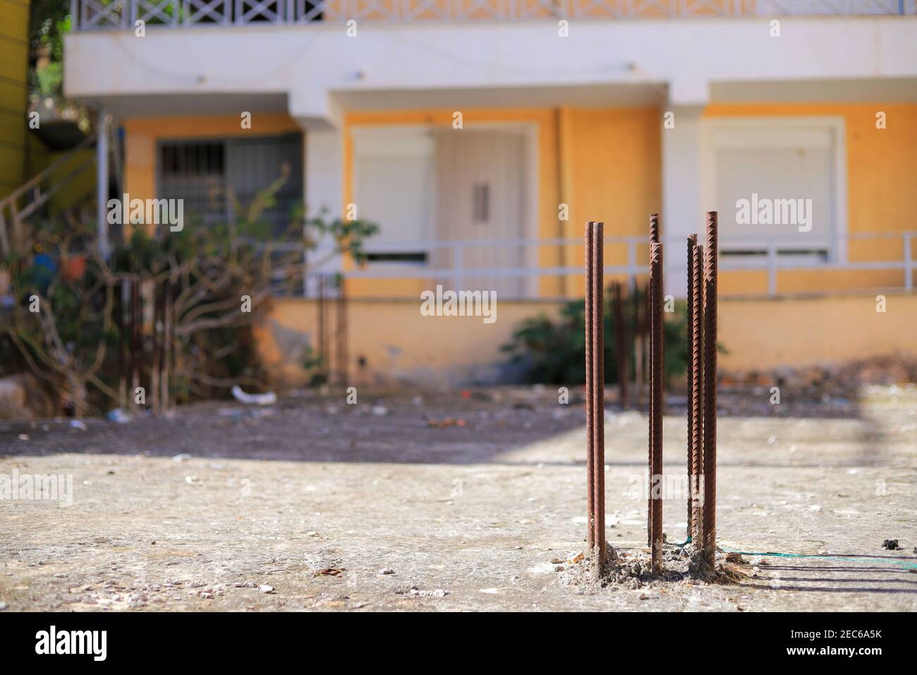 The reinforcement sticks out of the concrete floor of the building ...