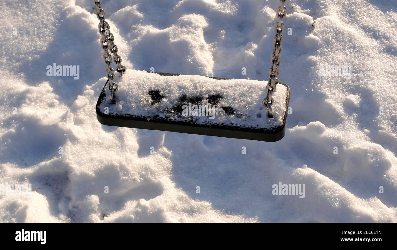 swing with snow cover in wintertime Stock Photo - Alamy