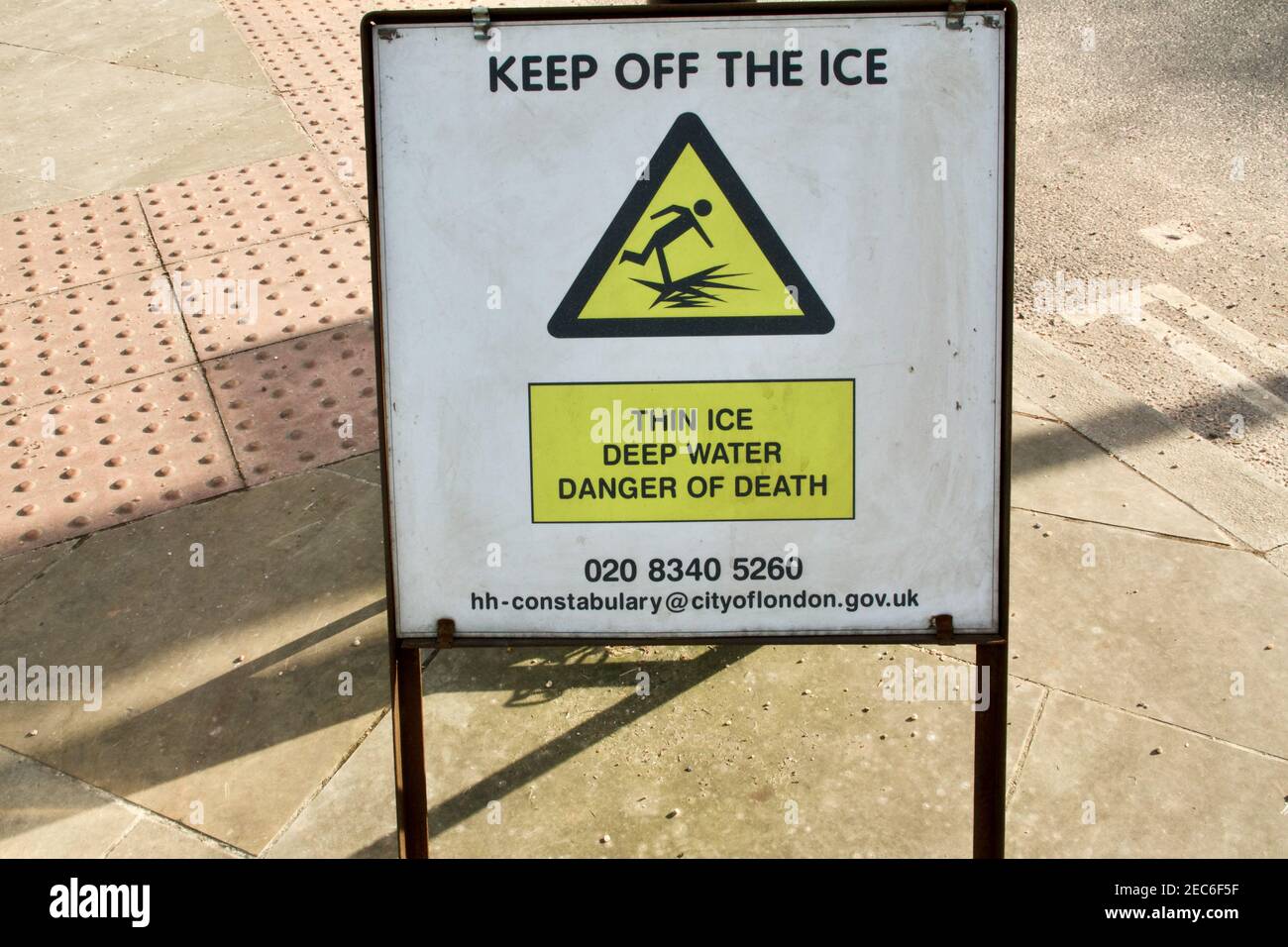 A "Keep off thin ice" sign warning "Danger of Death" placed next to ...