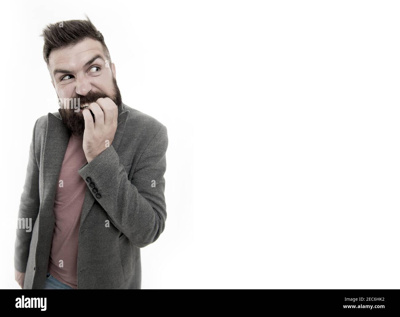 Man bearded hipster doubtful face bites finger while thinking. Nervous ...