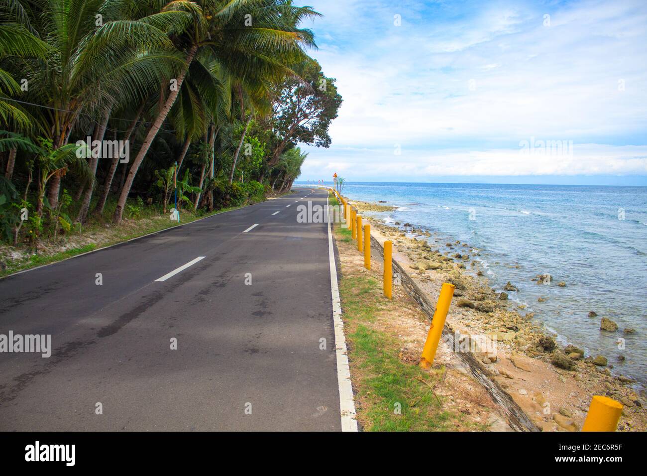 Empty coastal road by the sea. Tropical island holiday travel. Sunny ...