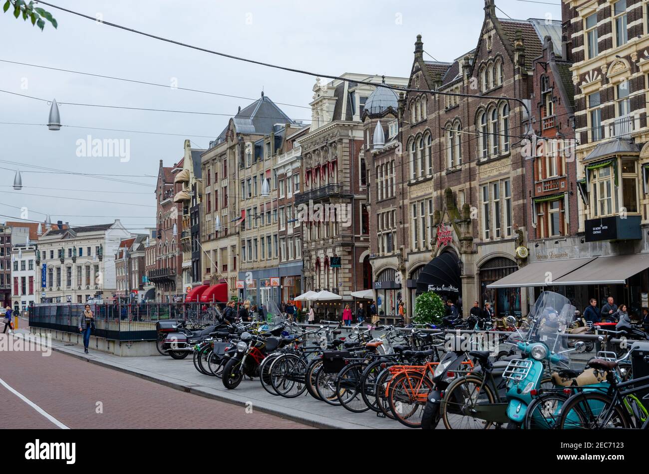 Bicycleas parked on a street of Amsterdam, Netherlands and traditional ...