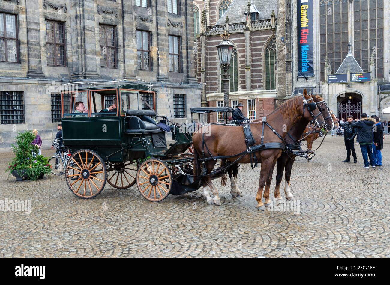 Carriage with two horses waiting in the Dam square in Amsterdam ...
