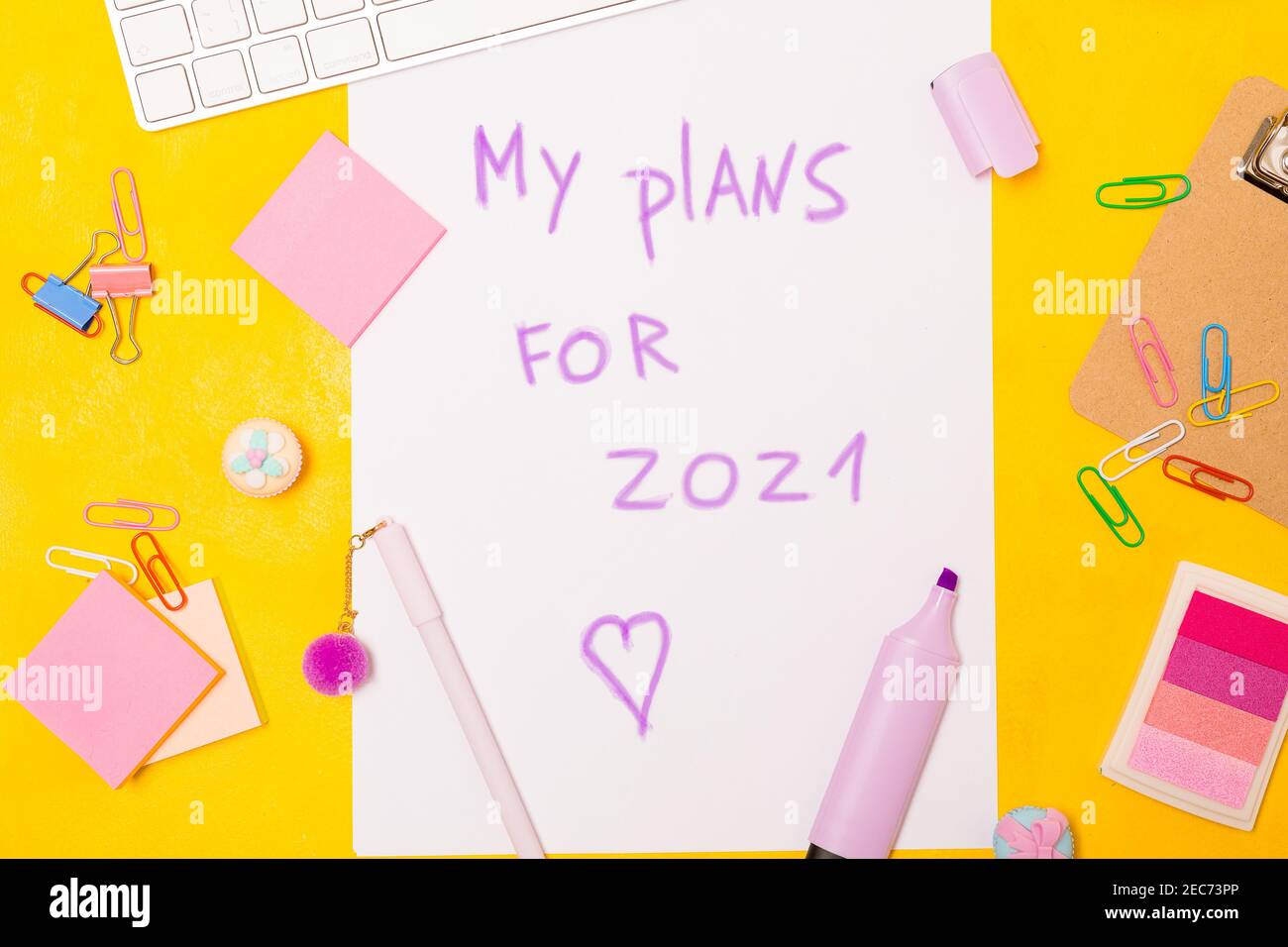 Phrase my plans for 2021 and various stationary and keyboard on yellow ...