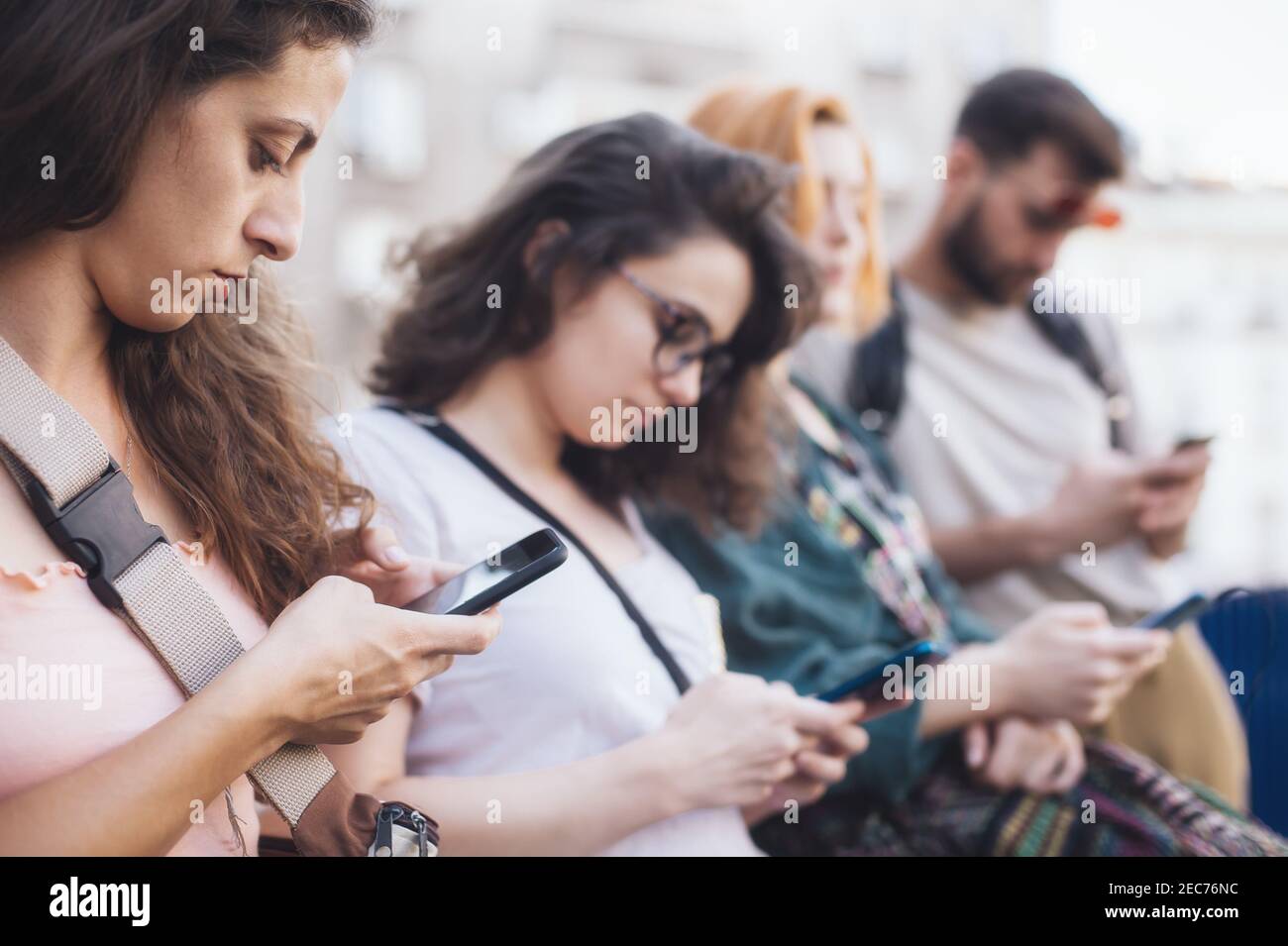 Alienation addiction. Group of friends using smartphones together ...