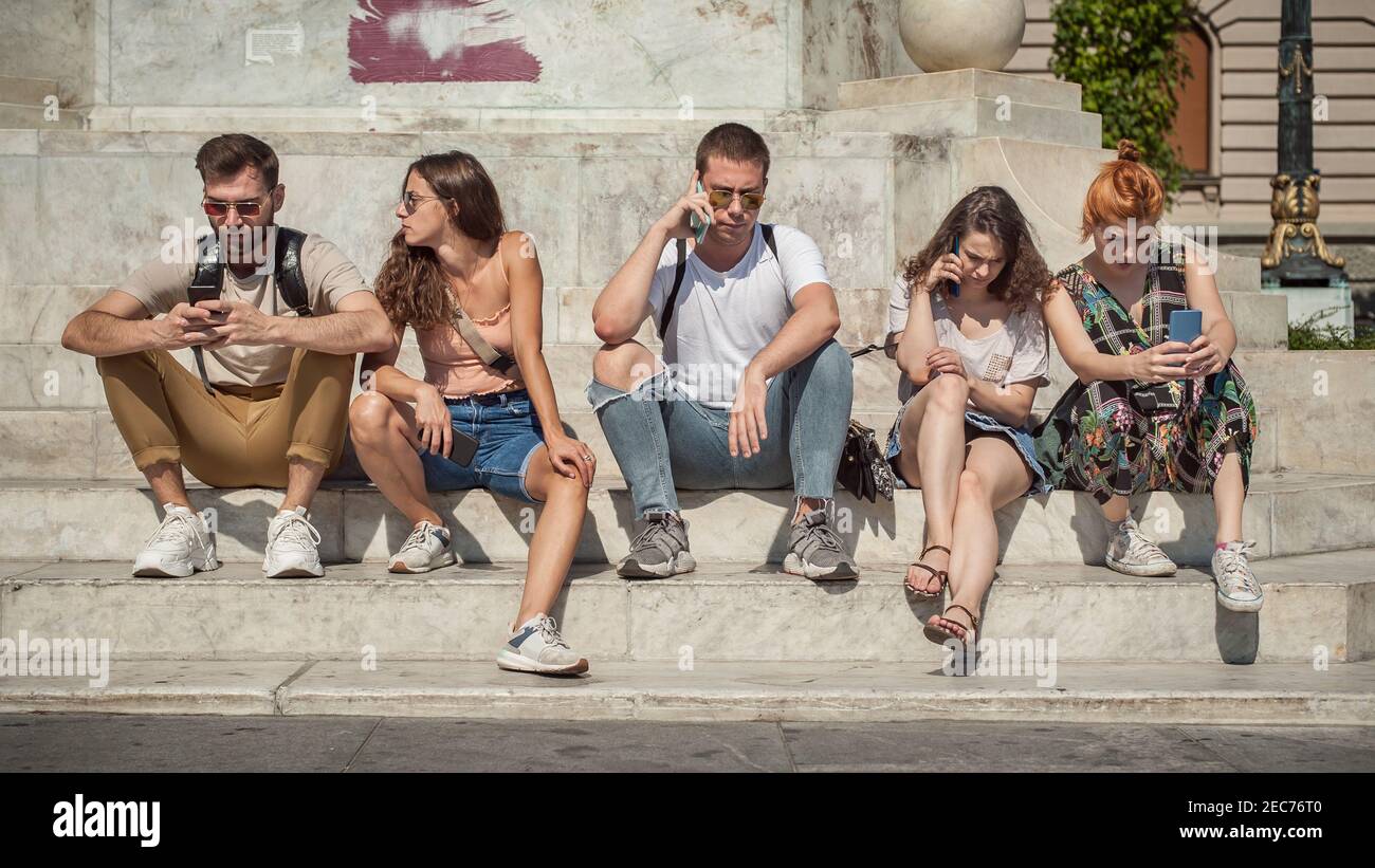 Alienation addiction. Group of friends using smartphones together ...