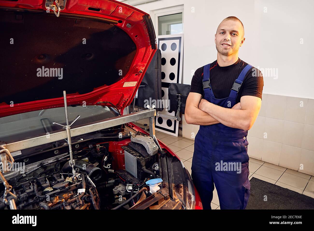 Repairing a car engine in auto-service center. Auto mechanic working in ...