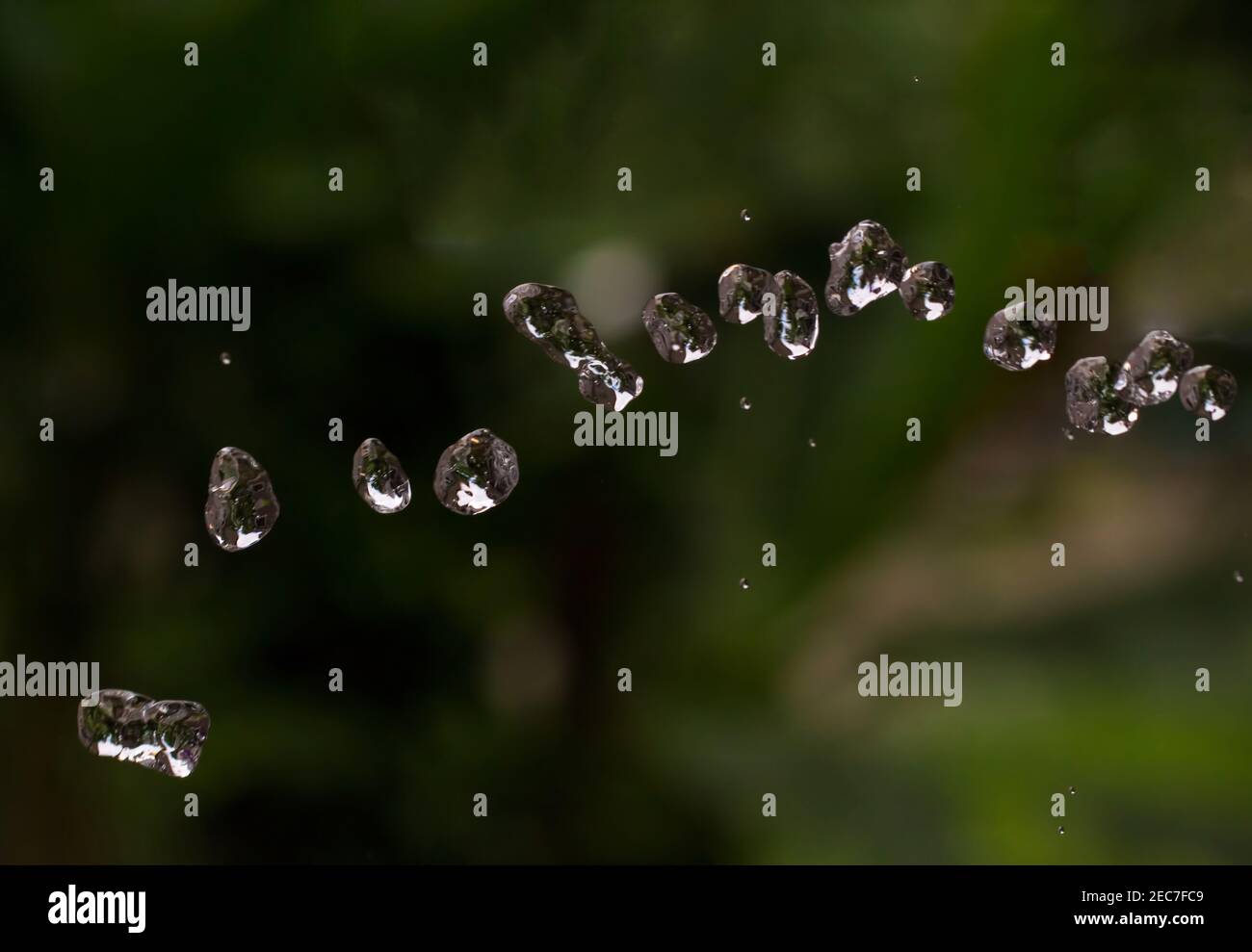 Water drops on natural background. Aqua drops flying in air. Rain drops ...