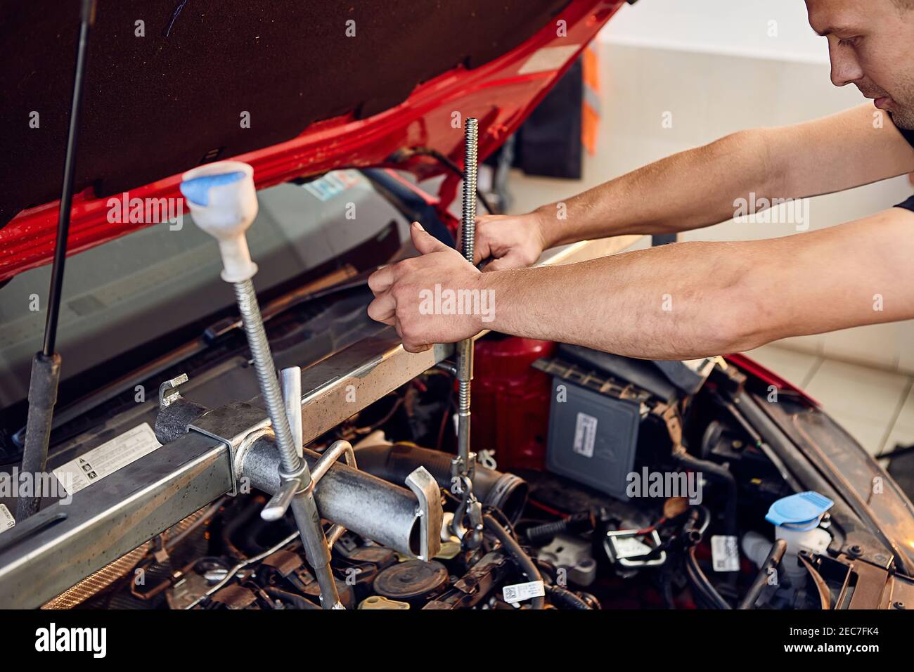 Repairing a car engine in auto-service center. Auto mechanic working in ...