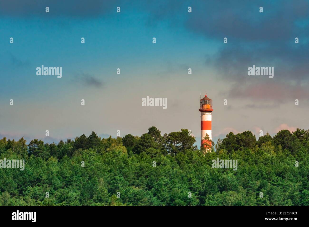 Panoramic view of lighthouse in forest at dusk sky background showing ...