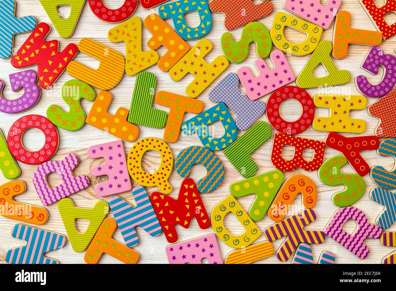 Colorful wooden letters of the alphabet on wooden background. Flat lay ...