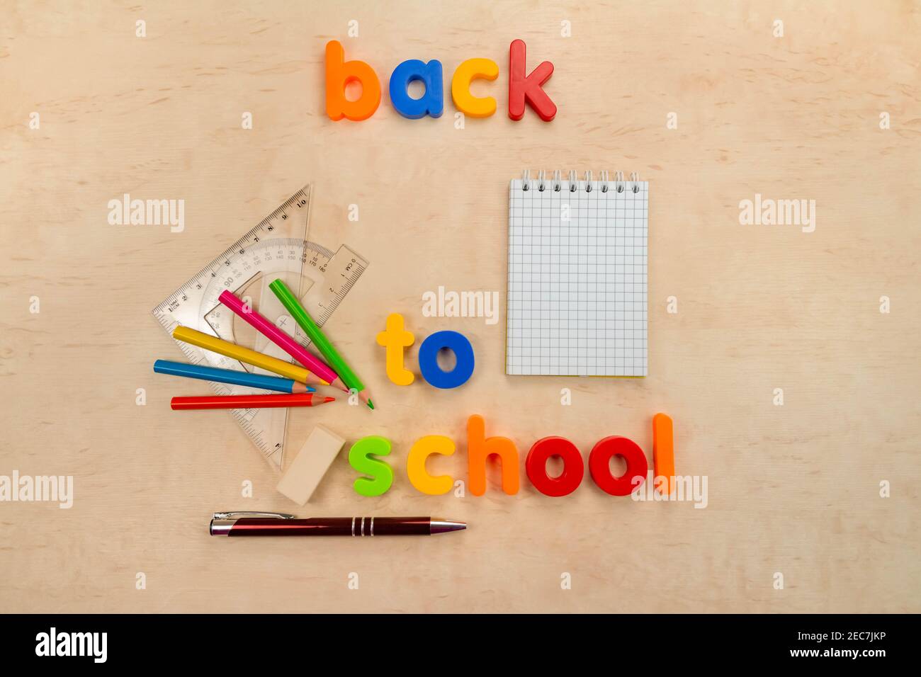 Back to school concept. Flat lay of wooden background with text of ...