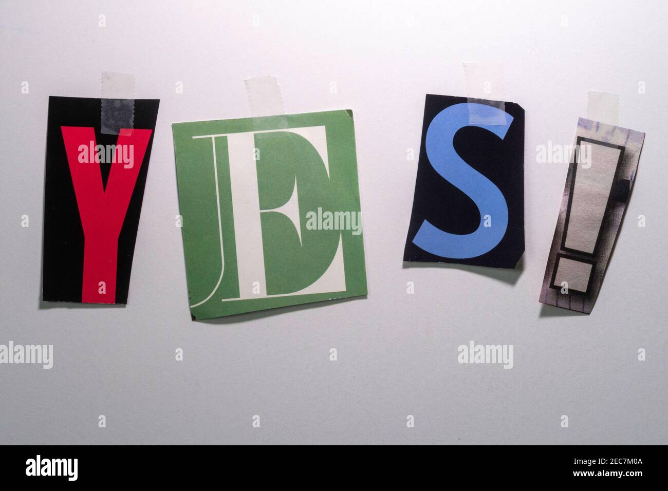 The word YES! on a bulletin board using cut-out paper letters in the ...