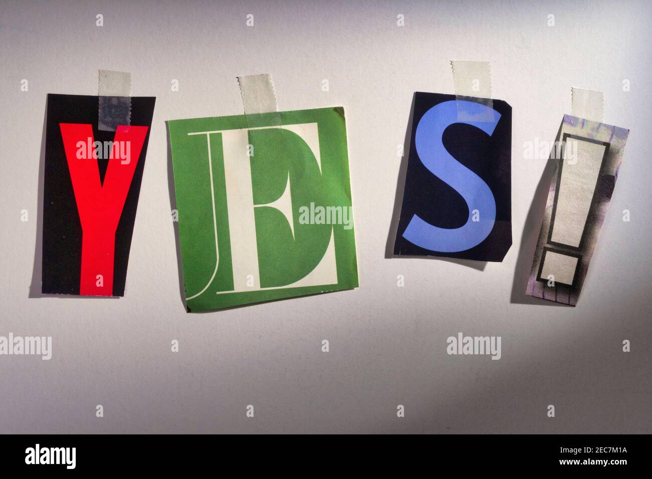 The word YES! on a bulletin board using cut-out paper letters in the ...