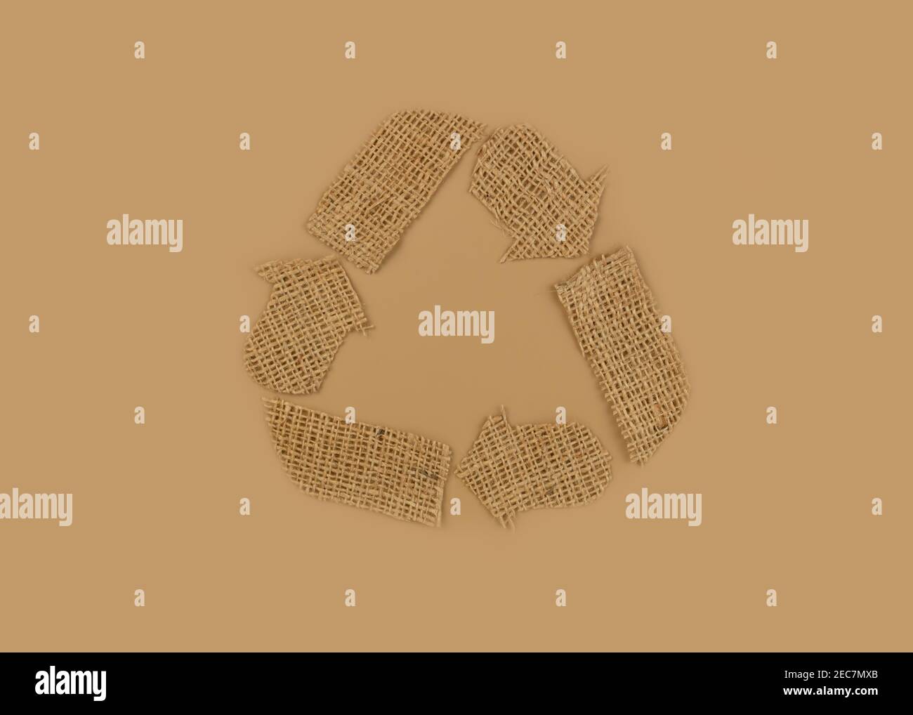 Recycling sign made of burlap on a beige background. Recycling and zero ...
