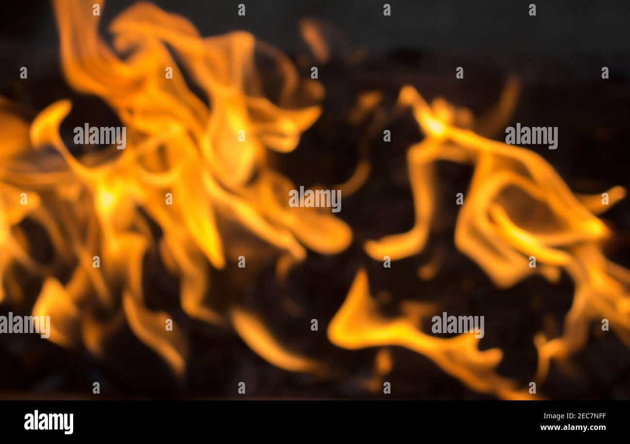 Yellow fire on lack coal. Abstract blurry photo for background. Blurred ...