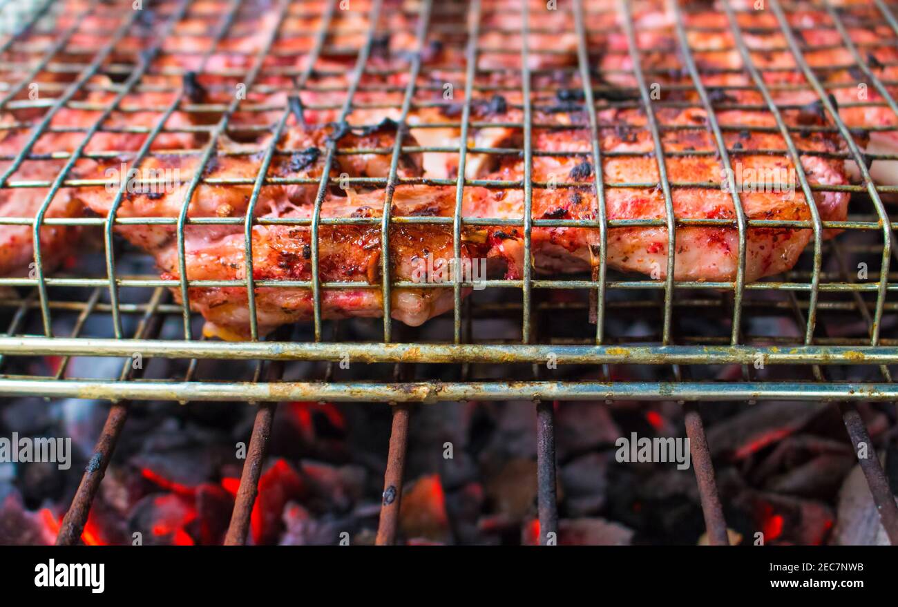 Grilled meat on fire closeup photo. Red meat barbecue cooking. Outdoor ...
