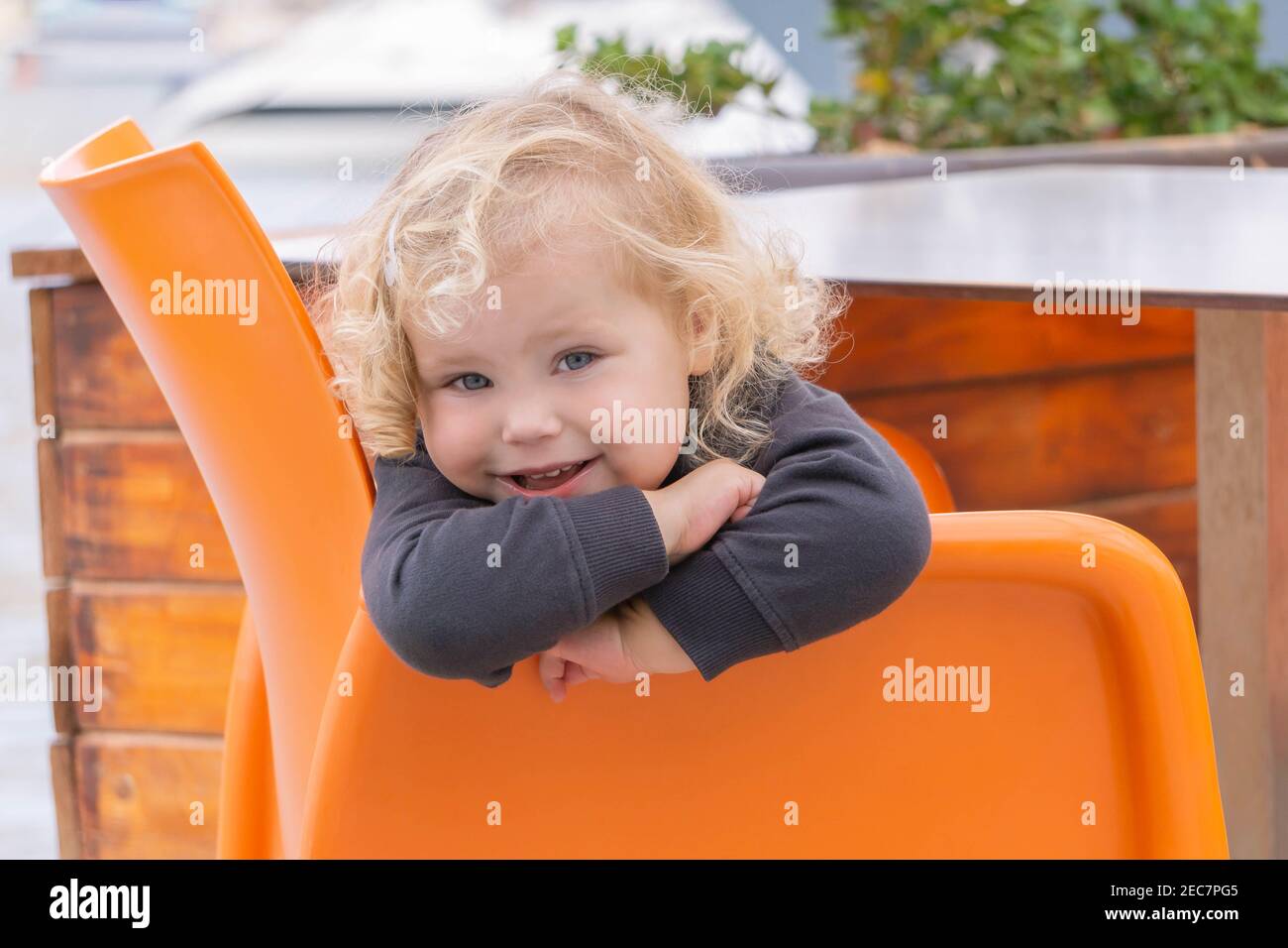 Little girl sitting in chair hi-res stock photography and images - Alamy