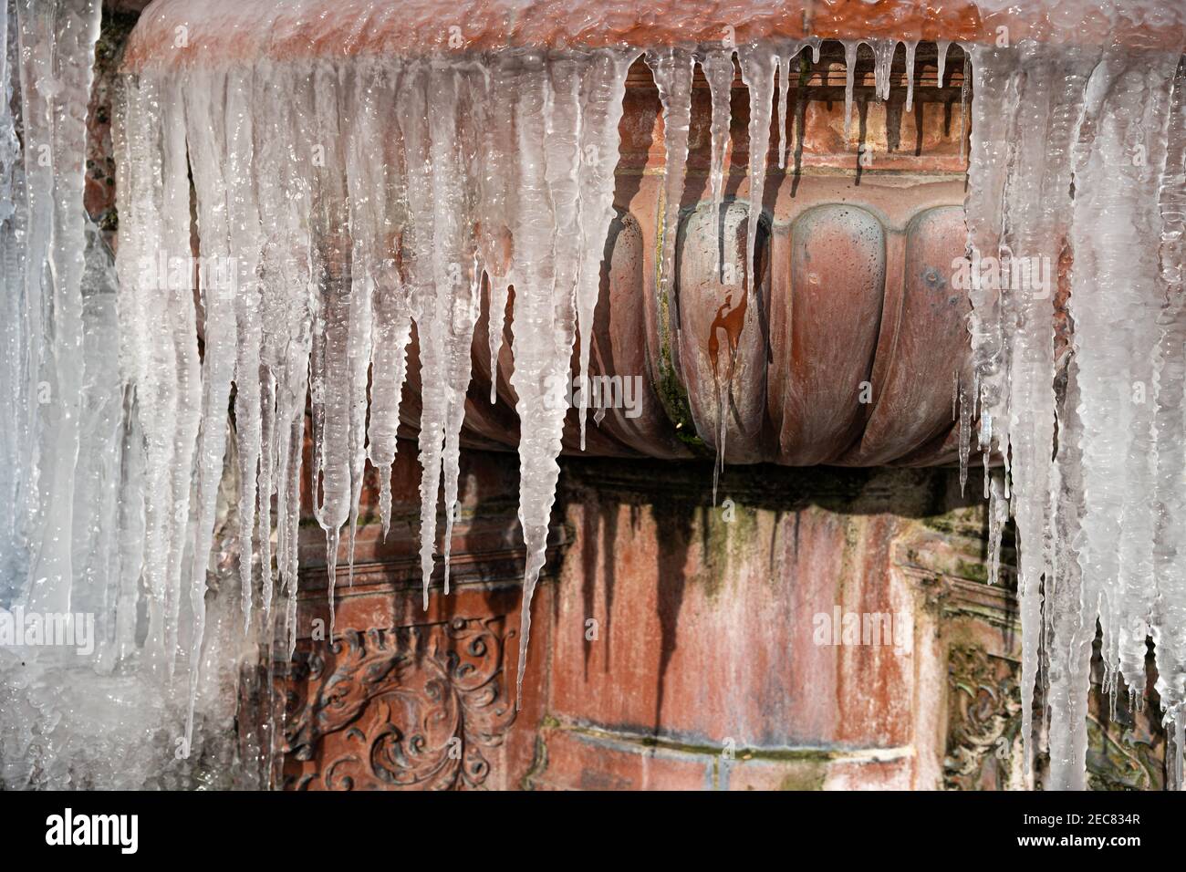 A frozen victorian fountain with large icicles, in Hanley Park, Stoke ...