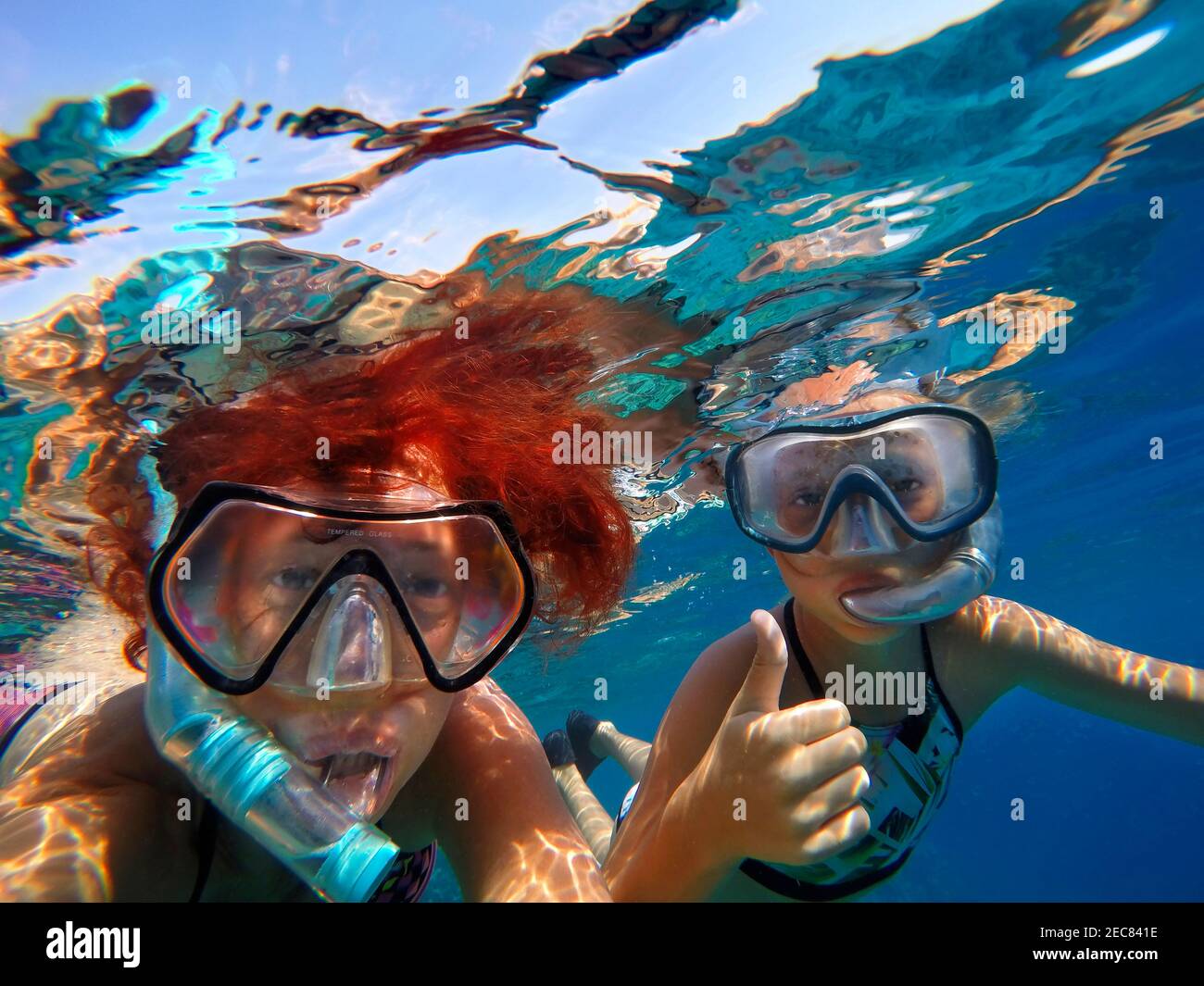 Tourists doing snorqueling in the waters of the Gulf of Aqaba in Jordan ...