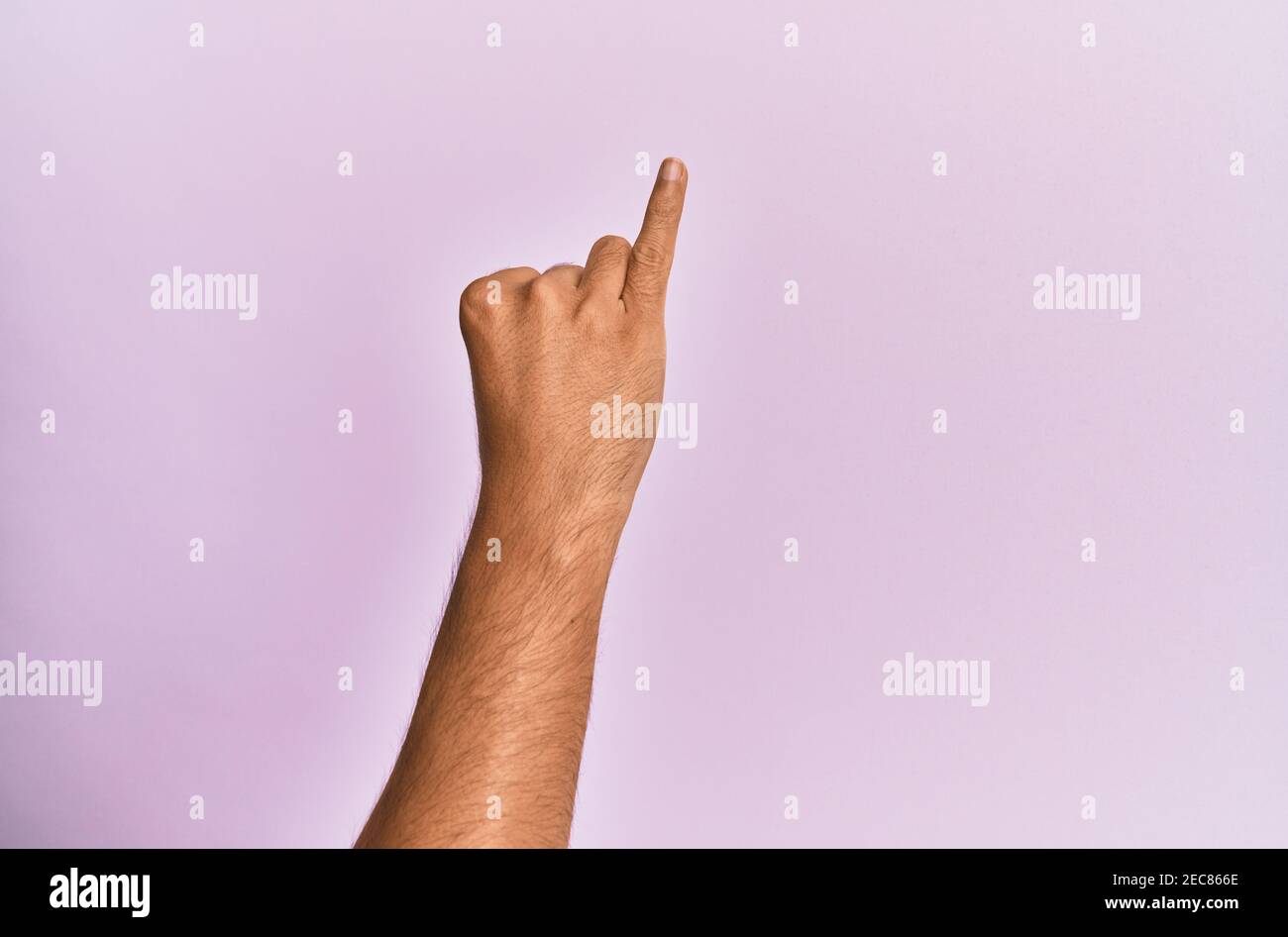 Arm and hand of caucasian young man over pink isolated background ...