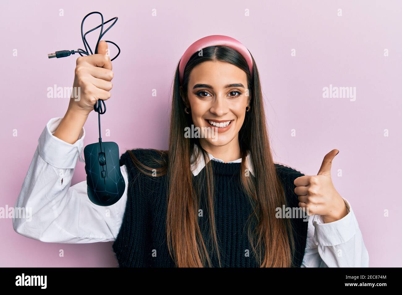 Beautiful brunette young woman holding computer mouse device smiling ...