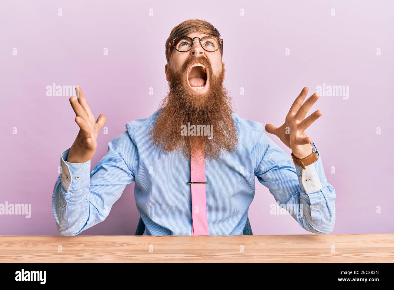 Young irish redhead man wearing business shirt and tie sitting on the ...