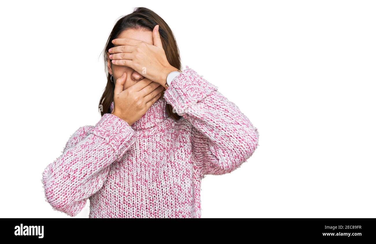 Young caucasian girl wearing wool winter sweater covering eyes and ...