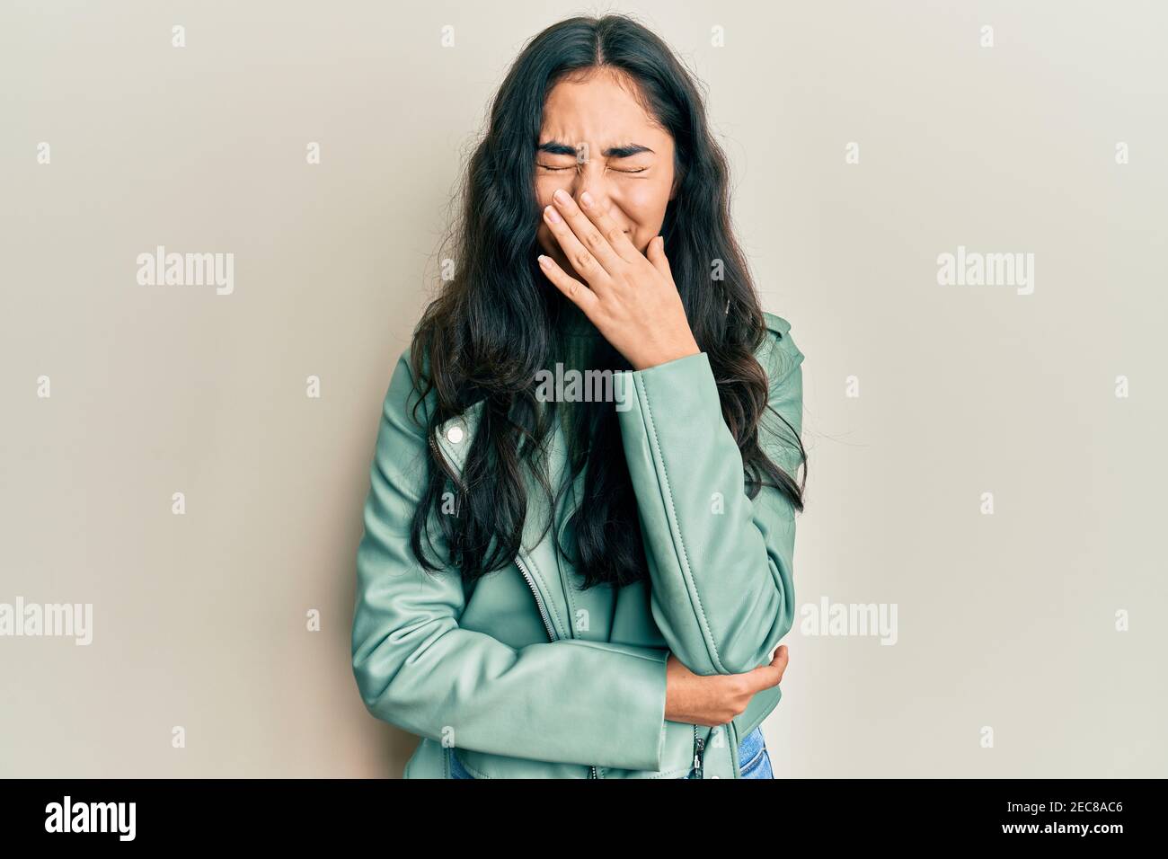 Hispanic teenager girl with dental braces wearing green leather jacket ...