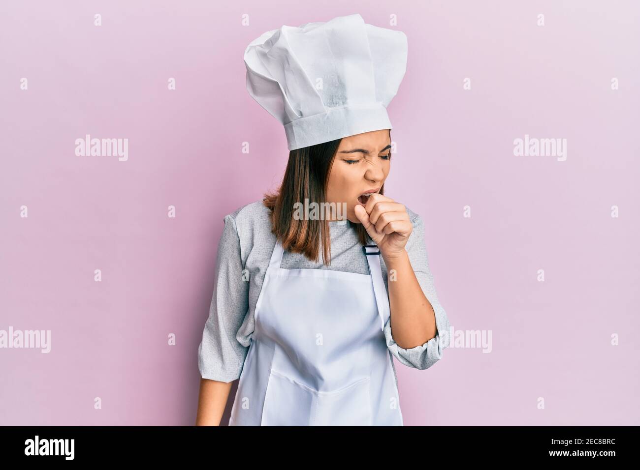Young blonde woman wearing professional cook uniform and hat shouting ...
