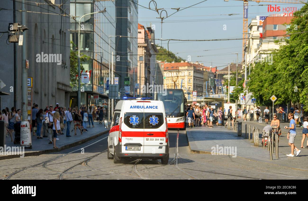 Prague, Czech Republic - July 2018: Emergency ambulance with blue lights flashing driving ...