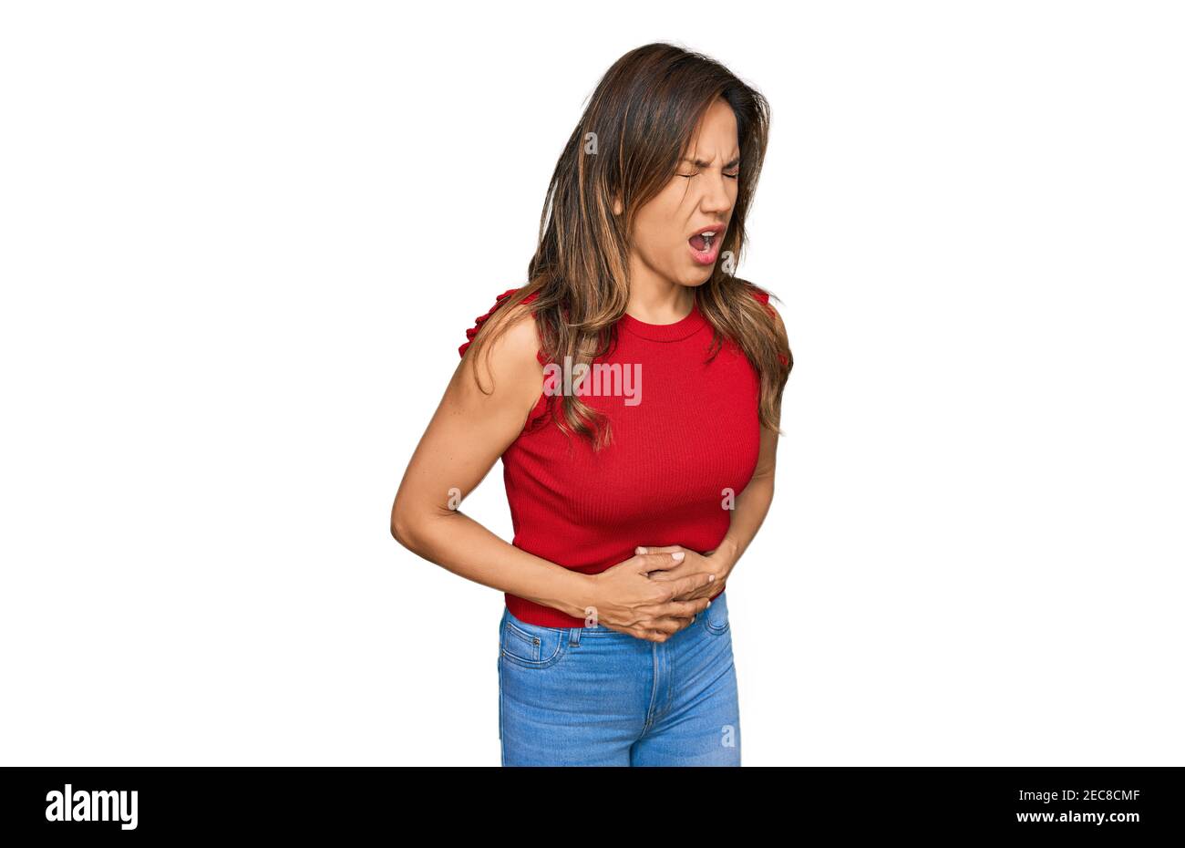 Young hispanic woman wearing casual clothes with hand on stomach ...