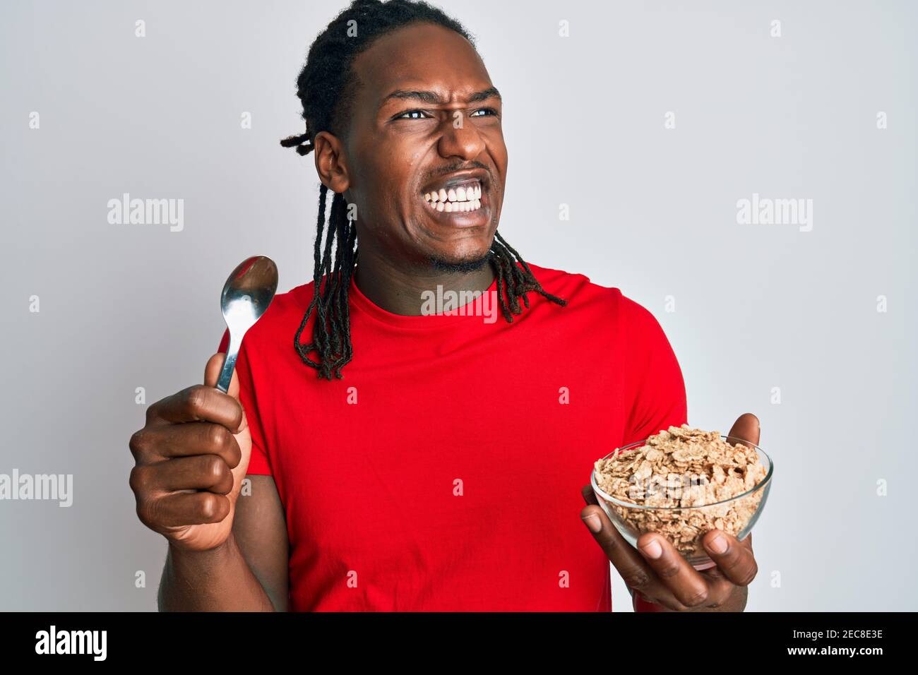 African american man with braids eating healthy whole grain celears ...