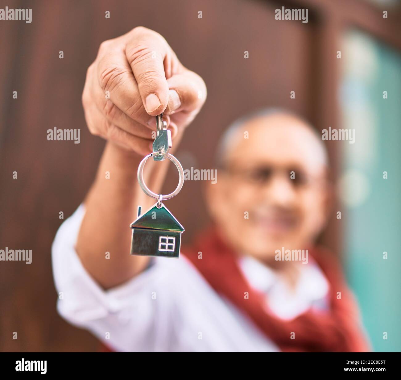 Senior man smiling happy holding new home key at the city Stock Photo ...