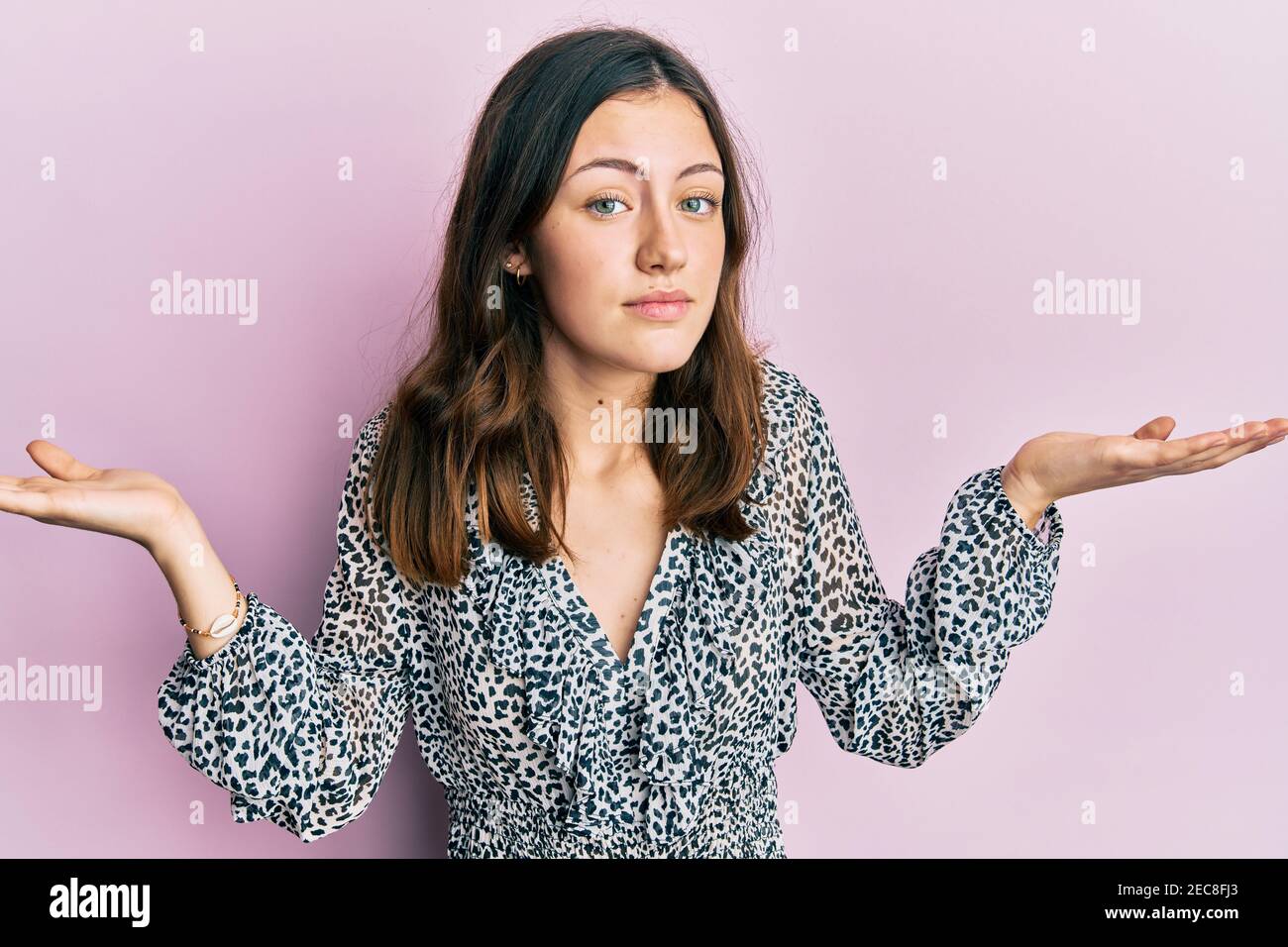 Young brunette woman wearing elegant animal print shirt clueless and ...