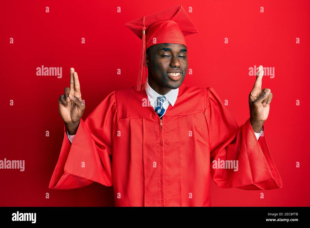 Young african american man wearing graduation cap and ceremony robe ...