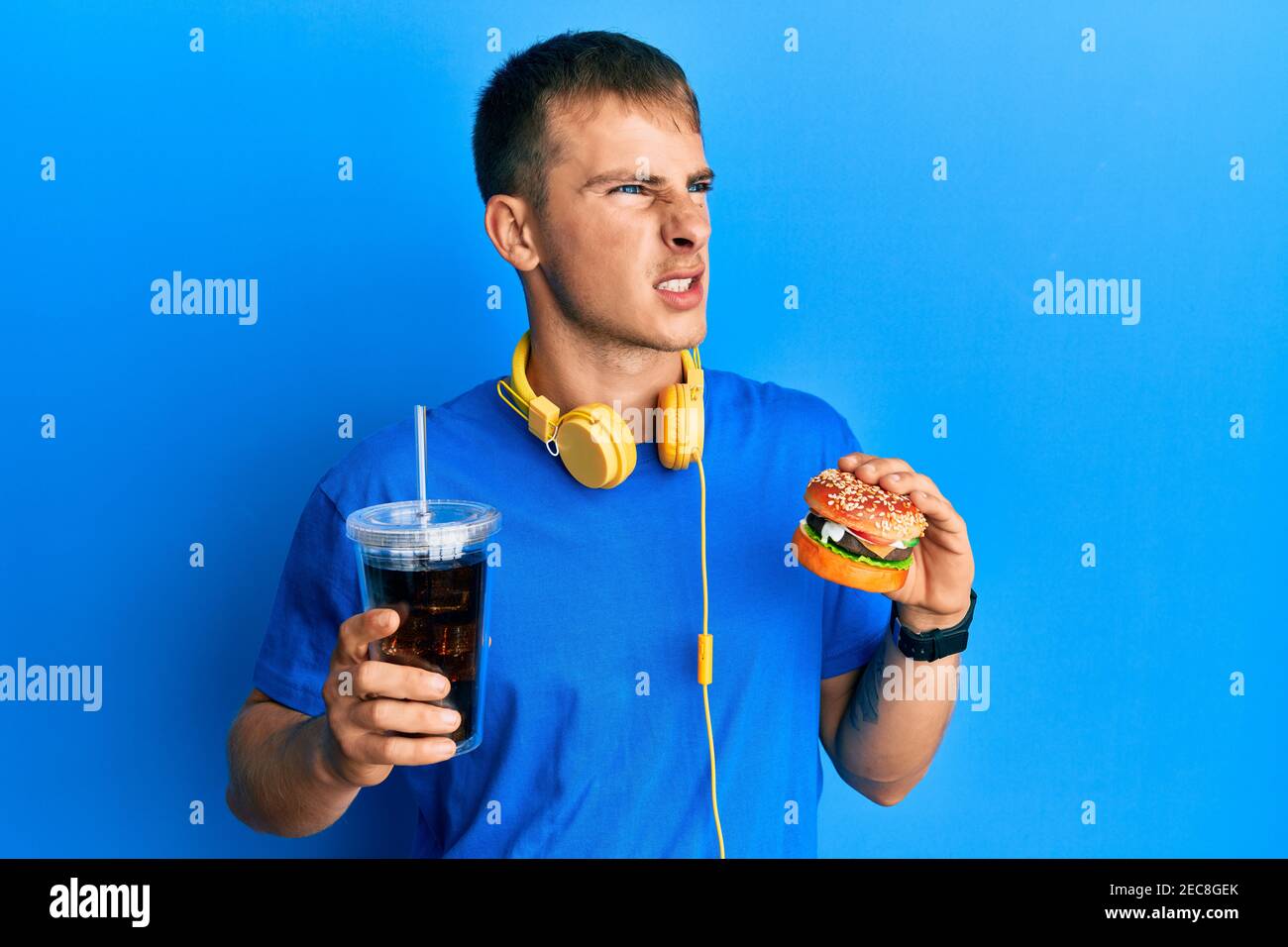 Portrait angry man eating hamburger hi-res stock photography and images ...