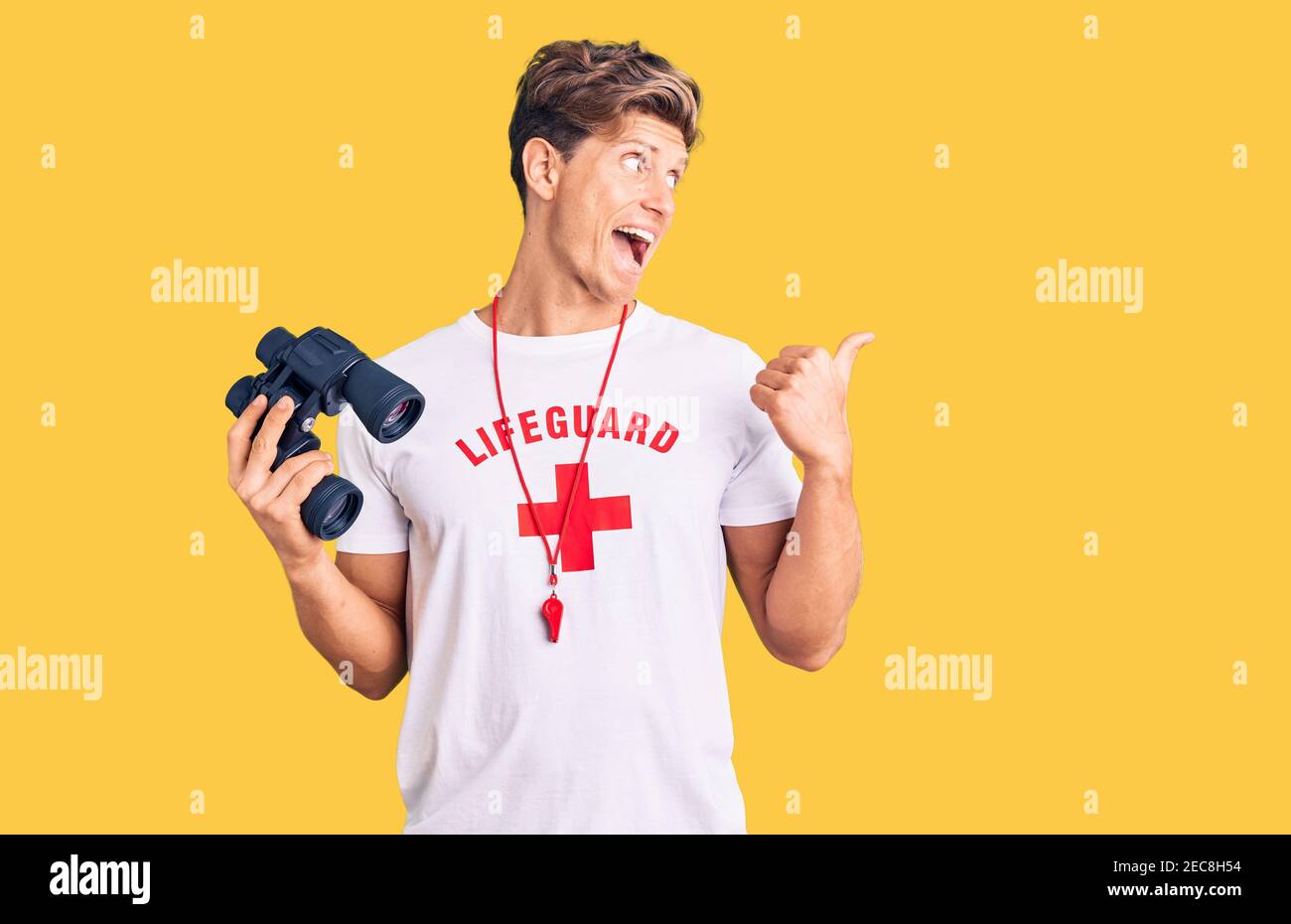Young handsome man wearing lifeguard t-shirt using binoculars pointing ...