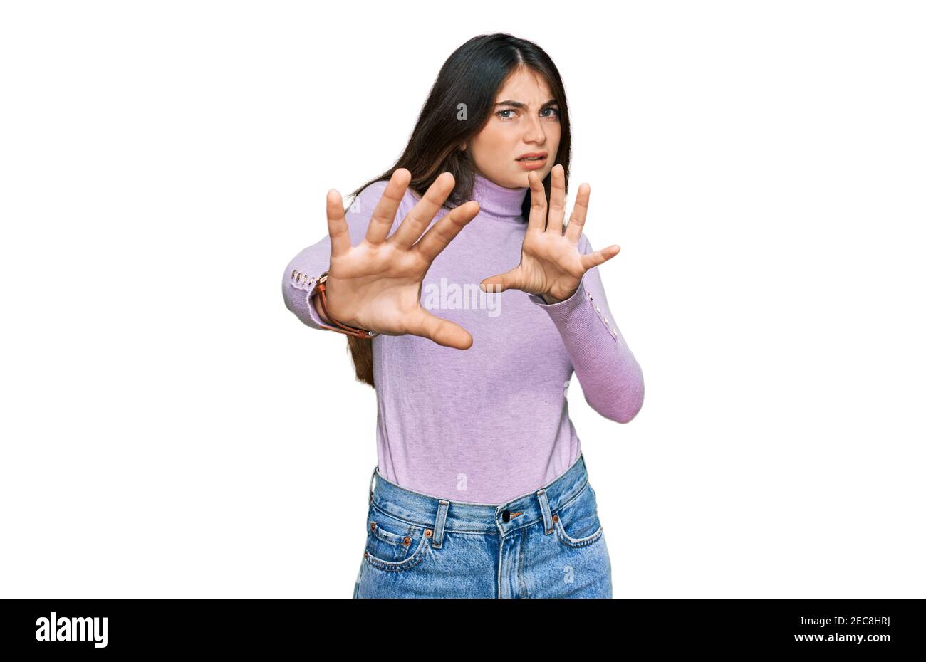 Young beautiful teen girl wearing turtleneck sweater afraid and ...