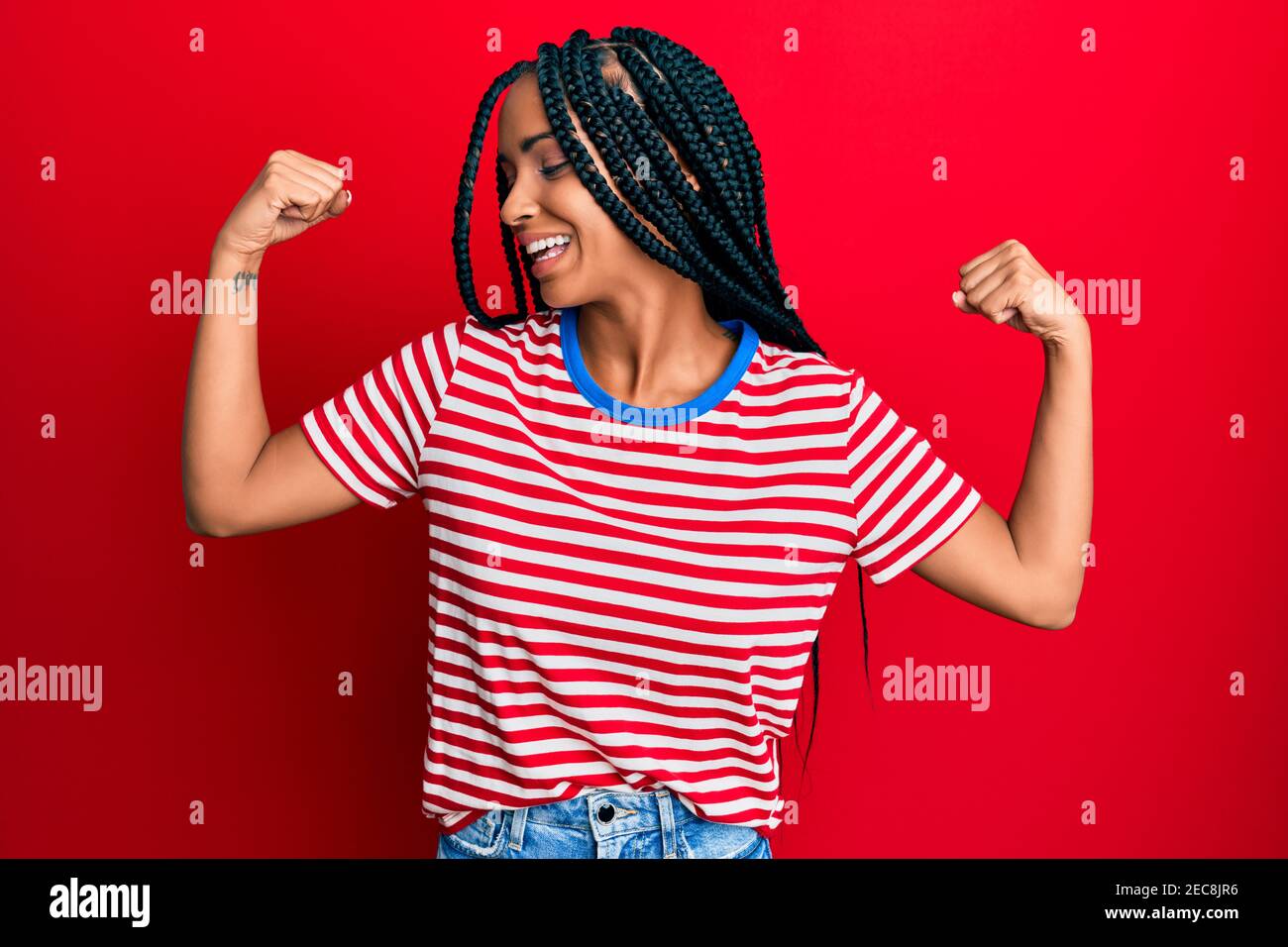 Beautiful Hispanic Woman Wearing Casual Clothes Showing Arms Muscles