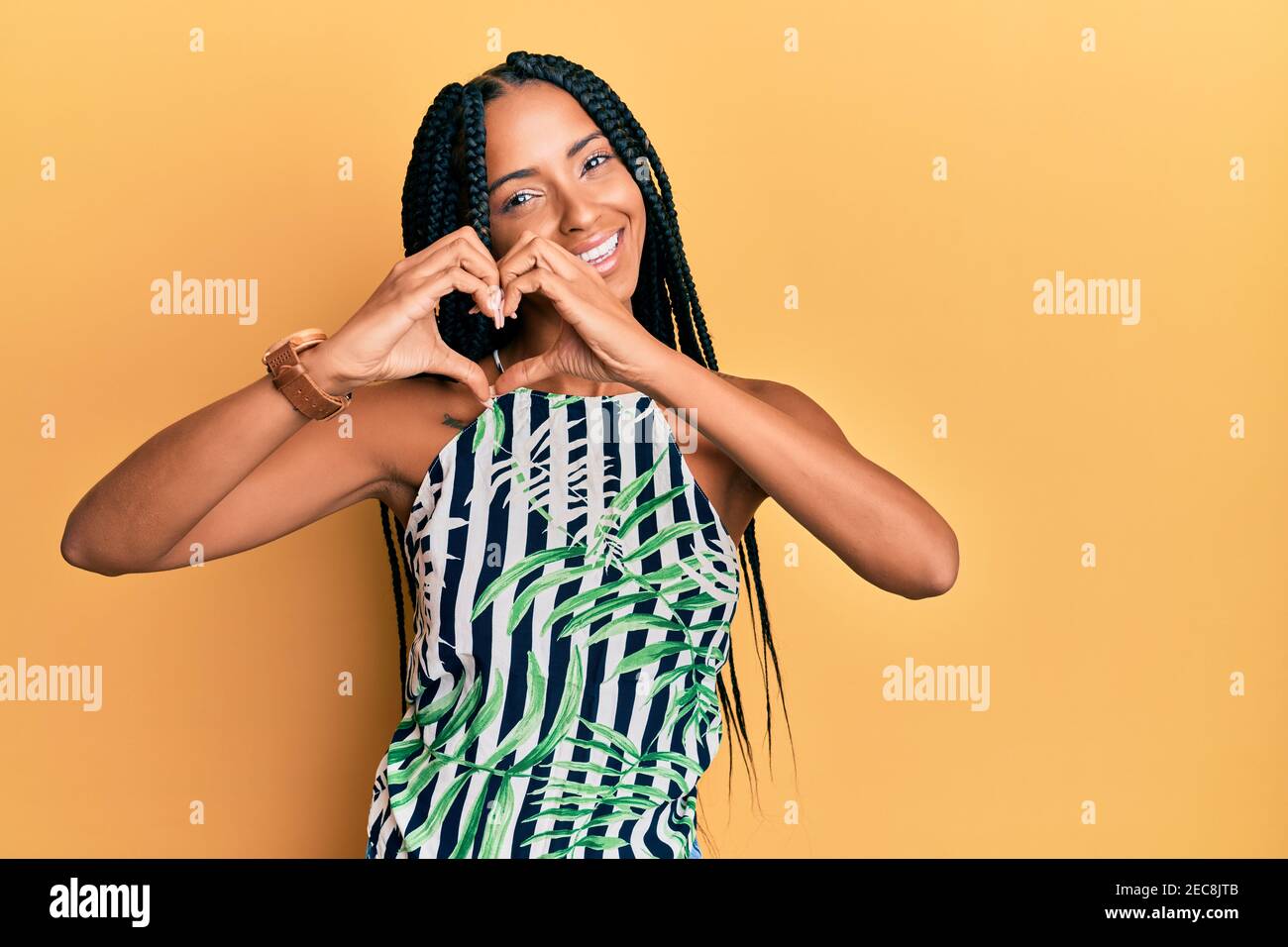 Beautiful hispanic woman wearing summer dress smiling in love showing ...